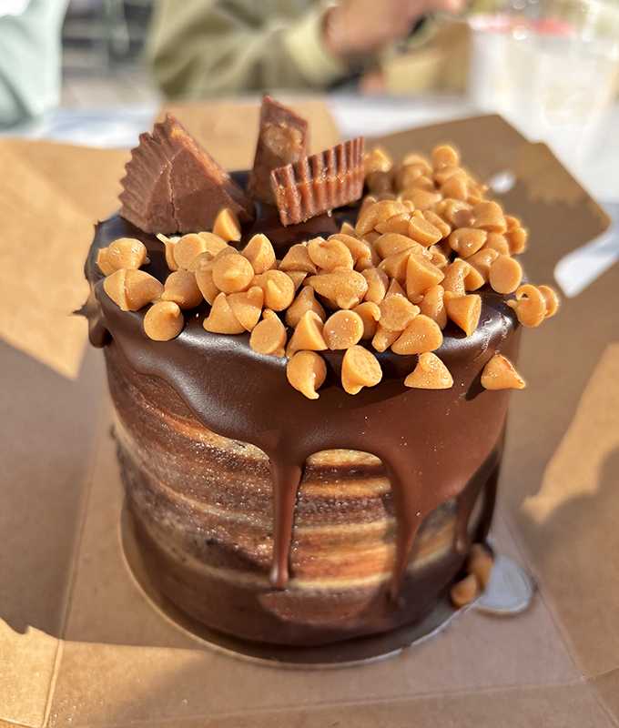 This chocolate peanut butter creation isn't just a cake—it's architecture, engineering, and art all wrapped in a drizzle of pure joy.