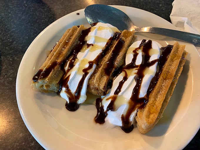 Churros drizzled with chocolate sauce—proof that the simplest desserts often deliver the most profound happiness.