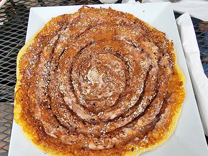 The cinnamon bun pancake—where breakfast meets dessert and nobody asks questions. That spiral of cinnamon sugar speaks a universal language of comfort.