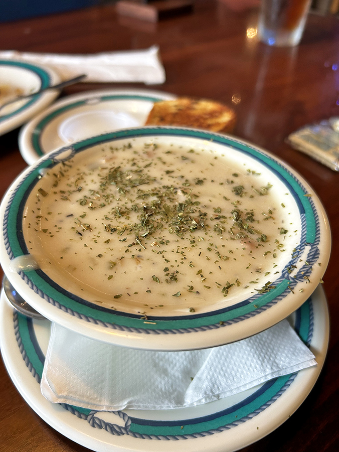 The legendary clam chowder—creamy, herb-flecked perfection that makes you wonder if mermaids might actually be the secret chefs.