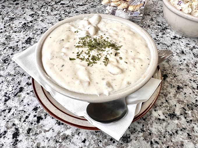 Clam chowder so creamy it should come with a warning label. That sprinkle of herbs on top? Just showing off at this point.