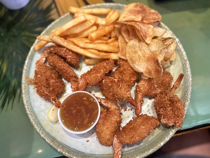 Coconut shrimp that look like they're wearing tiny beach attire – crispy, golden coats with a tropical sweetness that transports you straight to vacation mode.