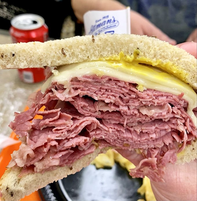 Every sandwich comes with its own tiny flag, as if to say, "I claim this mountain of corned beef in the name of delicious!"