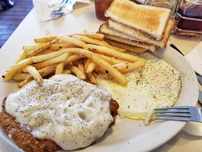 Country fried steak swimming in pepper-flecked gravy – comfort food so sincere it could make a therapist obsolete.