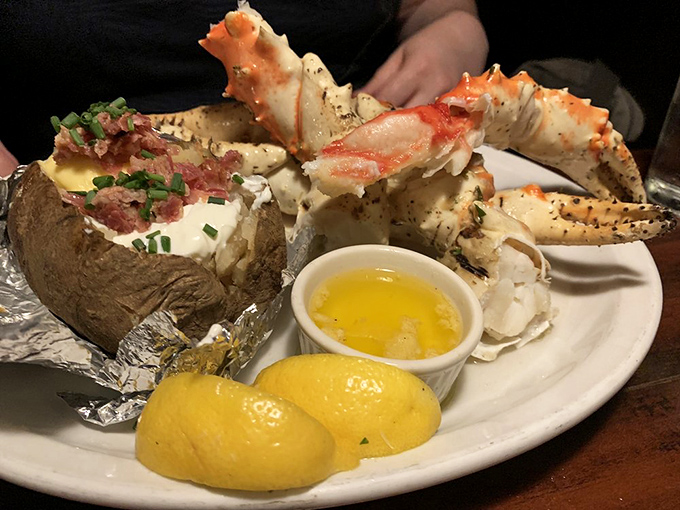 When land meets sea on one magnificent plate—king crab legs and a loaded baked potato create the surf-and-turf romance we all need.
