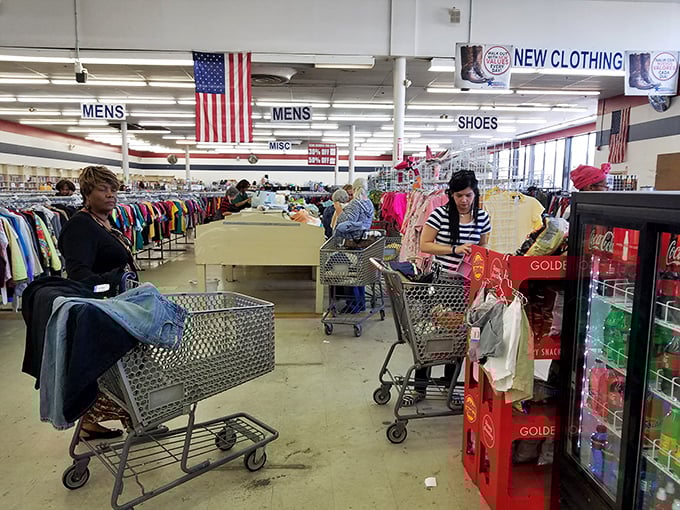 Shopping carts loaded with potential treasures navigate the well-organized aisles under the watchful gaze of Old Glory.