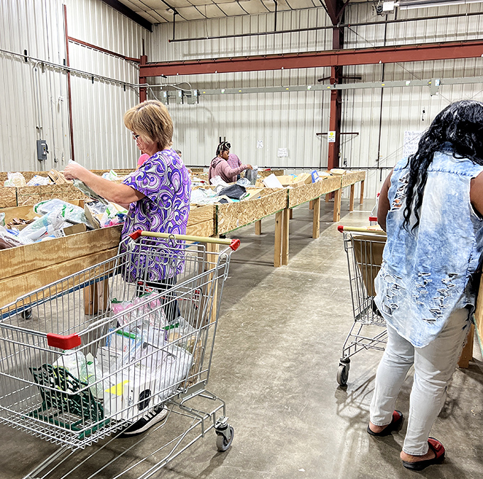 The treasure hunt in action—shoppers carefully sift through bins with the focused concentration of archaeologists on the verge of a major discovery.