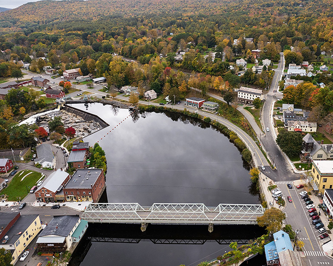 From above, the river's gentle curve cradles the village like a parent holding a child, protective and permanent.