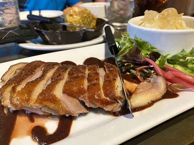 The duck breast, sliced to reveal that perfect medium-rare interior, proves this place takes its namesake seriously. That glaze though!