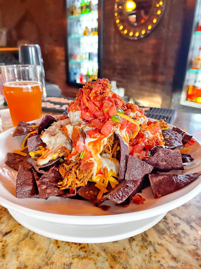 Nachos that require a topographical map to navigate—a mountain range of chips, cheese, and pulled pork that dares you to reach the summit.