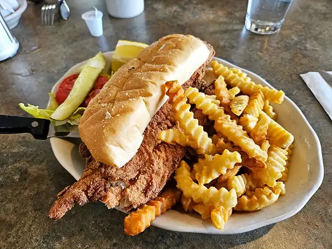 The fish sandwich arrives with an honor guard of crispy fries. It's the kind of simple pleasure that makes you wonder why you ever bother with fancy restaurants.