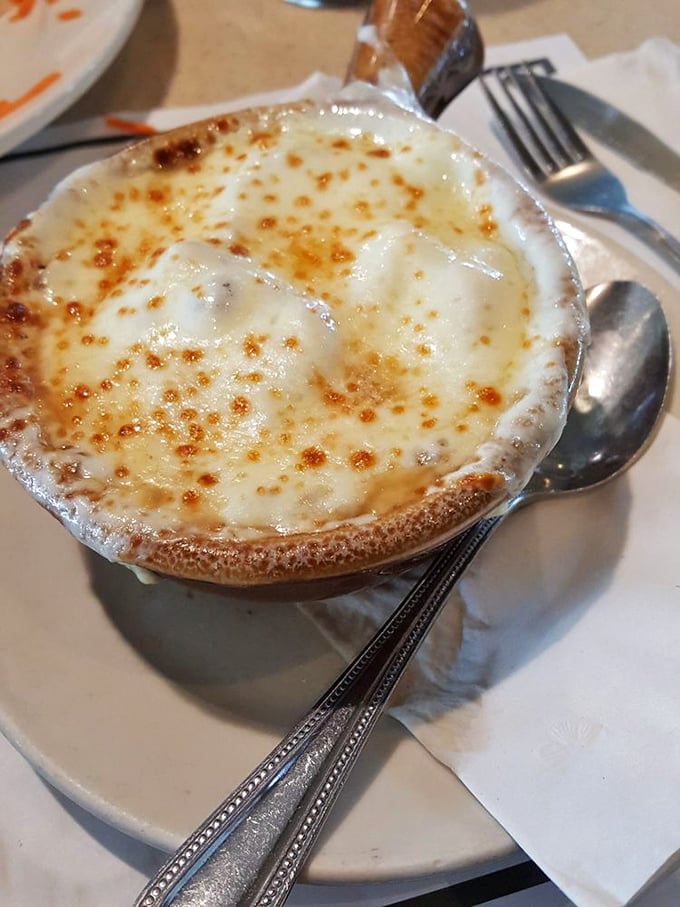 This isn't just French onion soup—it's a cheese-crowned miracle in a crock. The perfect balance of sweet onions, savory broth, and that glorious broiled cheese cap.
