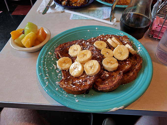 French toast that makes you question every other breakfast decision you've ever made. Those bananas aren't garnish—they're essential supporting actors.