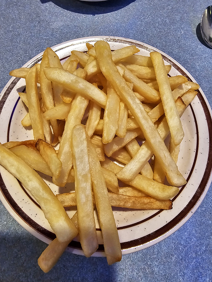 French fries so perfectly golden they deserve their own retirement plan. Crispy on the outside, fluffy within—life's simple pleasures.