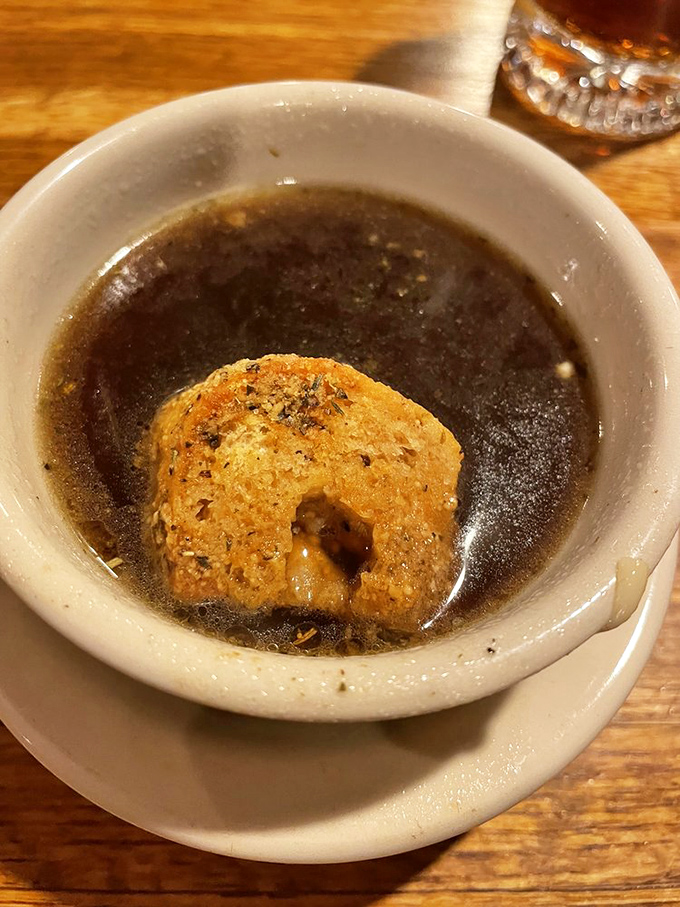 French onion soup – where a golden cheese-topped crouton floats like a delicious island in a savory sea. Comfort in a crock.