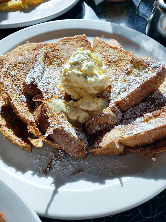 French toast that transforms humble bread into a powdered sugar masterpiece—proof that breakfast can indeed be dessert.