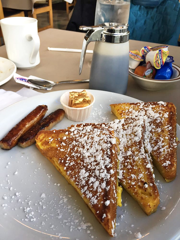 The French toast that launched a thousand return visits, dusted with powdered sugar like fresh snow on a delicious mountain range.