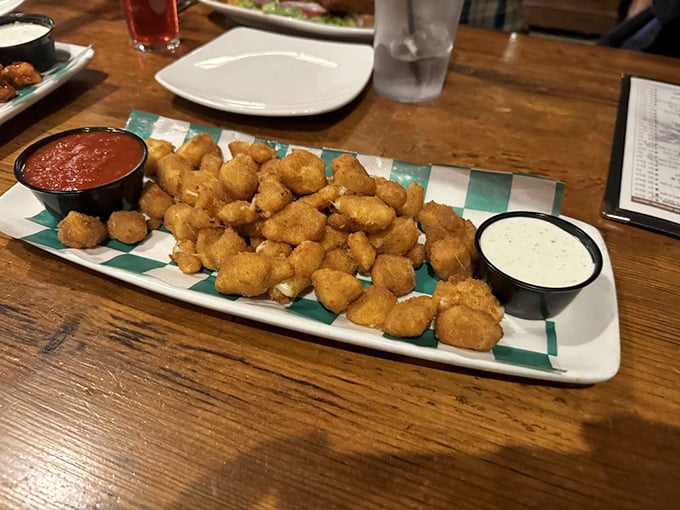 These aren't just any cheese curds – they're little golden nuggets of happiness, served with dipping sauces that make you question why you'd ever eat them any other way.
