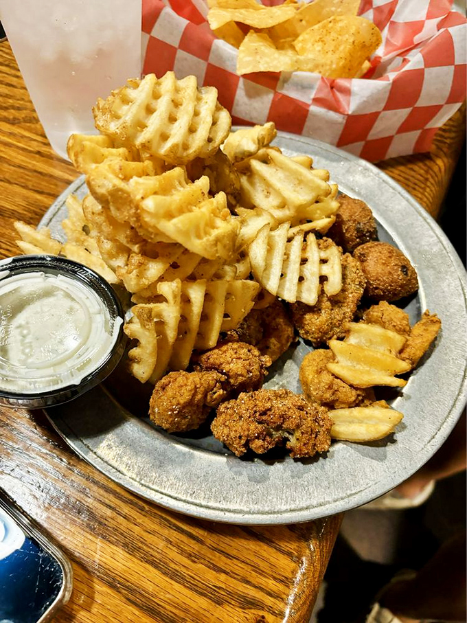 Golden-fried treasures from the sea paired with waffle fries—a plate that makes you want to high-five the chef.
