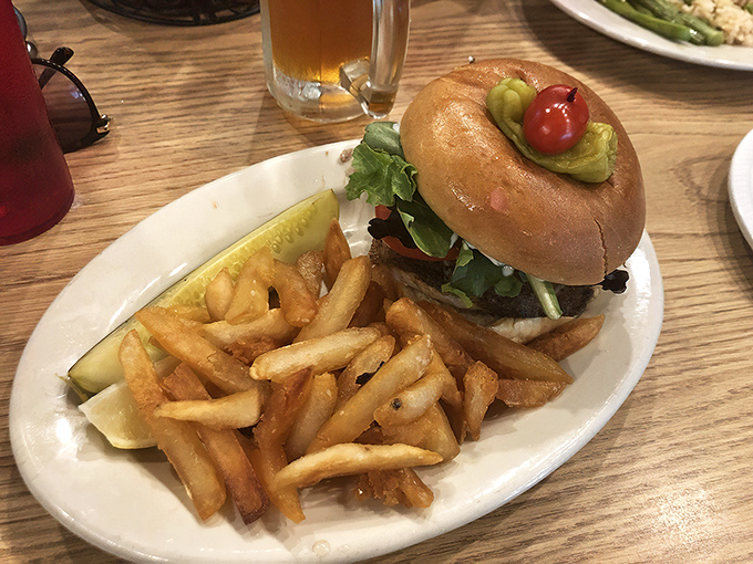 The legendary grouper sandwich in all its glory – a monument to simplicity done right. That golden-brown fillet spilling over the edges of the bun is Florida's edible sunshine. 
