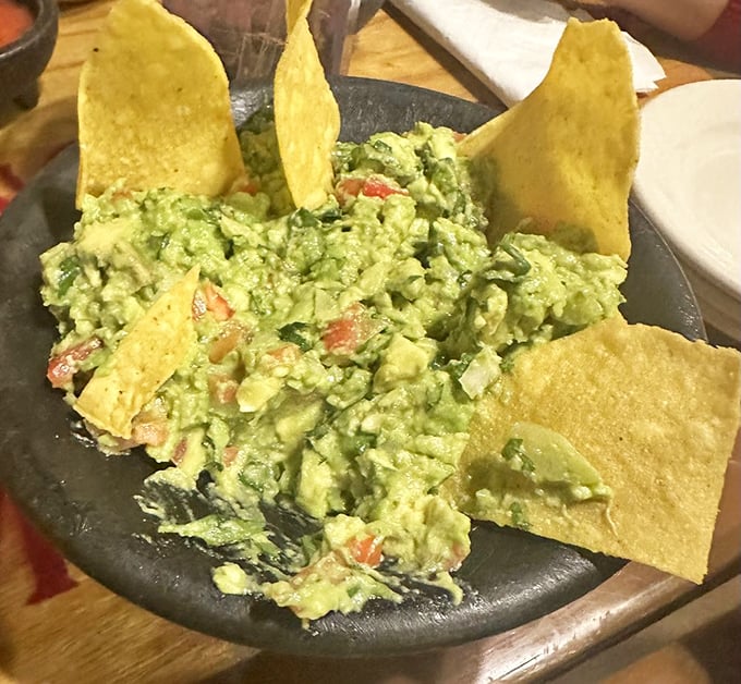 Fresh guacamole that deserves its own spotlight. Chunky, vibrant, and studded with tomatoes, it's the avocado's highest calling—especially when scooped up with those perfectly crisp tortilla chips.