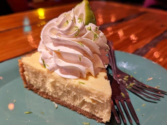 Key lime pie done right—tangy-sweet filling, graham cracker crust, and that cloud of whipped cream like the perfect Florida day on a plate.
