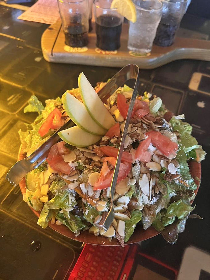 The Satch Salad isn't just a prelude to pizza – it's a colorful composition of greens, apples, nuts, and seeds that deserves its own standing ovation.
