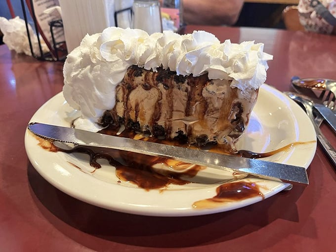 When a slice of ice cream pie looks this good, dessert isn't optional—it's mandatory. The whipped cream mountain alone deserves its own zip code.