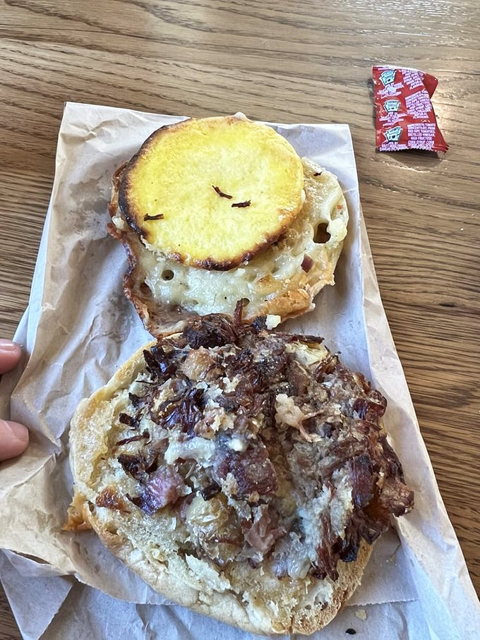 This isn't just a breakfast sandwich—it's morning salvation between bread. Those caramelized onions and melted cheese are working overtime on flavor duty.