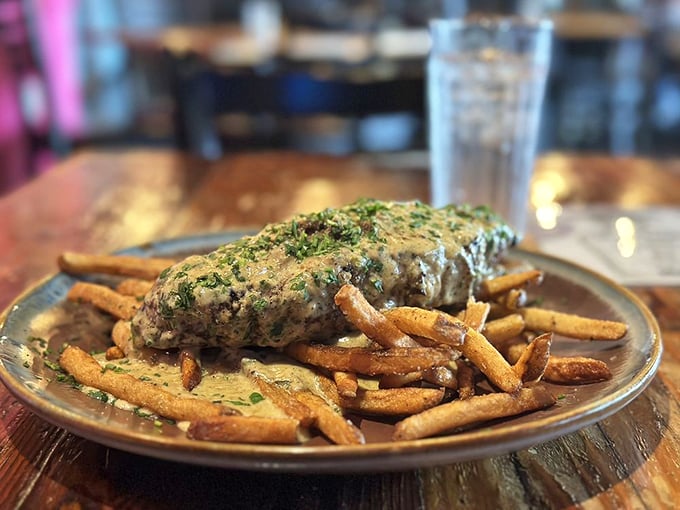 Johnny's steak doesn't just sit on those fries – it lounges like it owns the place. That cream sauce is practically begging for a spoon.