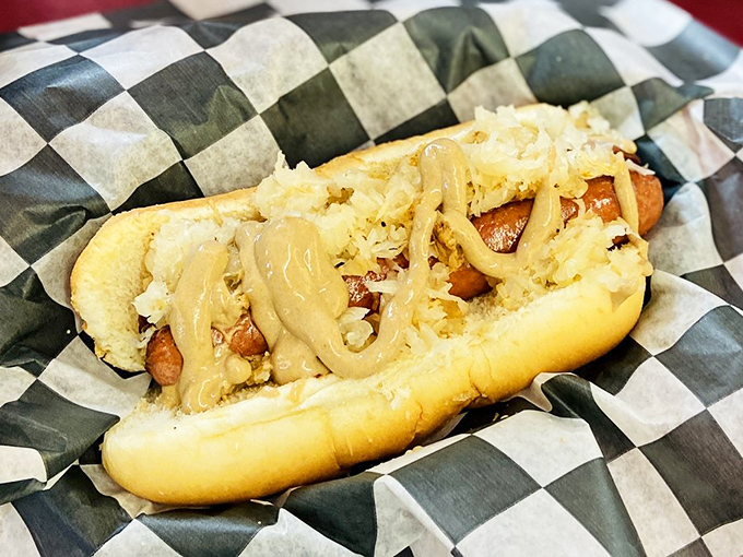 This isn't just any hot dog—it's a kielbasa masterpiece nestled in a pillowy bun, smothered in sauerkraut and mustard that means business.
