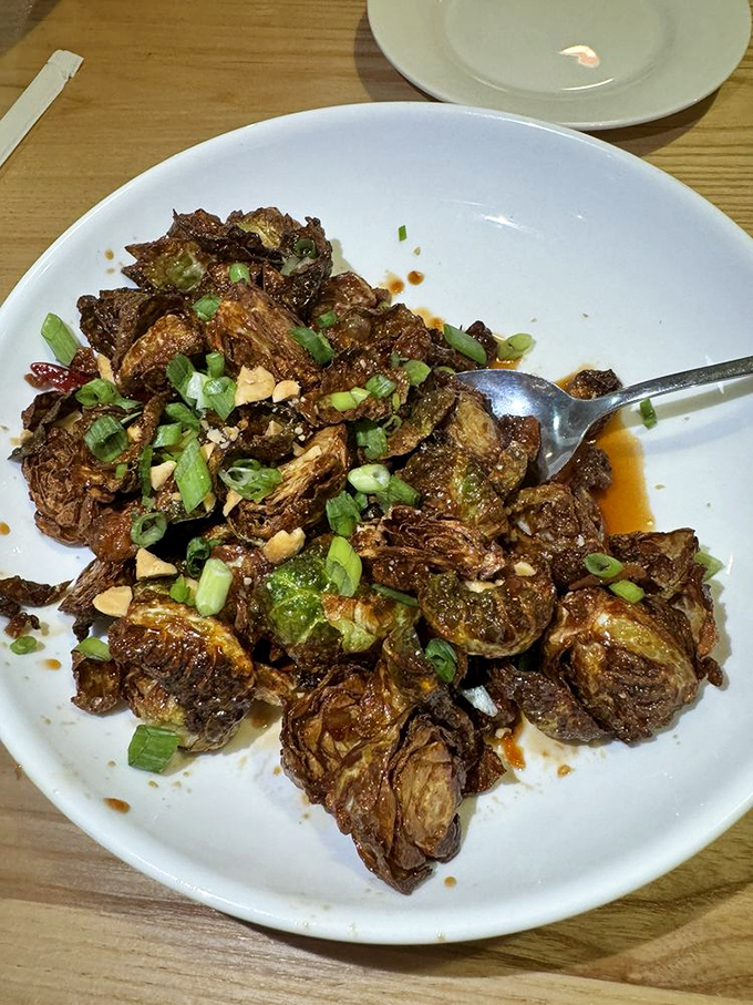 These aren't your grandmother's Brussels sprouts. Crispy, savory, and topped with scallions and peanuts—vegetable redemption at its finest.
