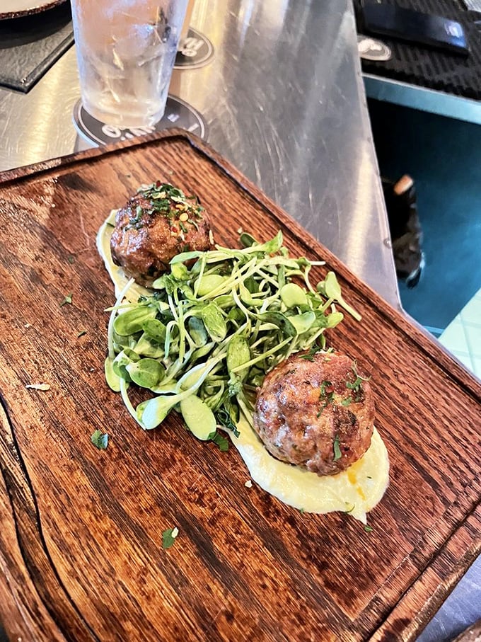 These lamb meatballs don't just sit on the plate—they perform, with supporting actors avocado crème and microgreens stealing scenes.