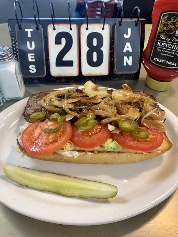 A sandwich that tells a story – caramelized onions, jalapeños, and tomatoes creating the perfect supporting cast for a hearty meatloaf star.