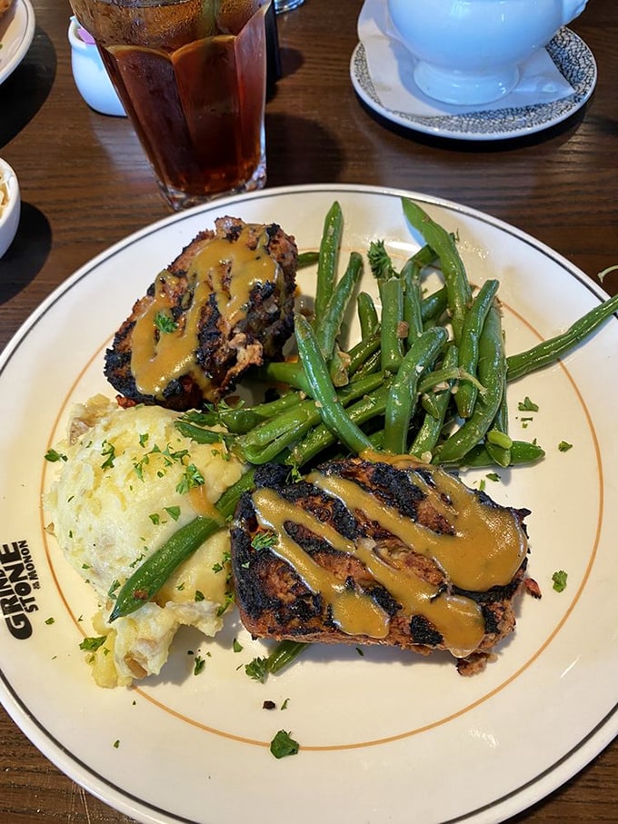 Not your mama's meatloaf (though she'd approve) – draped in savory sauce alongside green beans that actually taste like vegetables should.