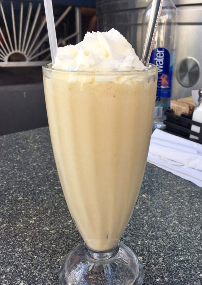 A vanilla milkshake so thick you'll get an arm workout with your dessert—topped with whipped cream that's basically announcing "no regrets."