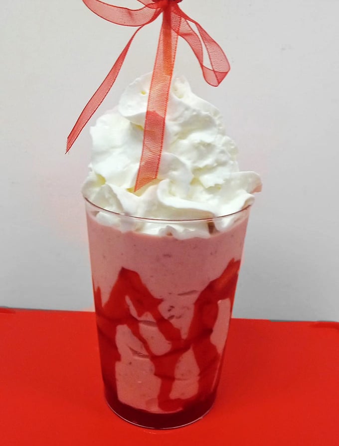 This strawberry shake isn't just a drink, it's dessert with a straw—complete with whipped cream mountain and that perfect ribbon garnish. 