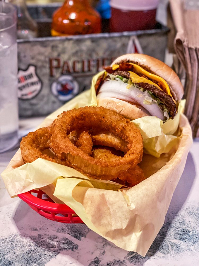 The mini bacon cheeseburger with onion rings – proof that "mini" is relative at Hodad's, where even the smaller options require a game plan before eating.