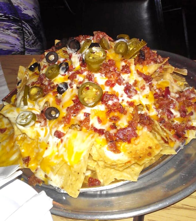 Nachos that require a structural engineer's approval. The jalapeños aren't just toppings; they're exclamation points in this cheese-covered story.