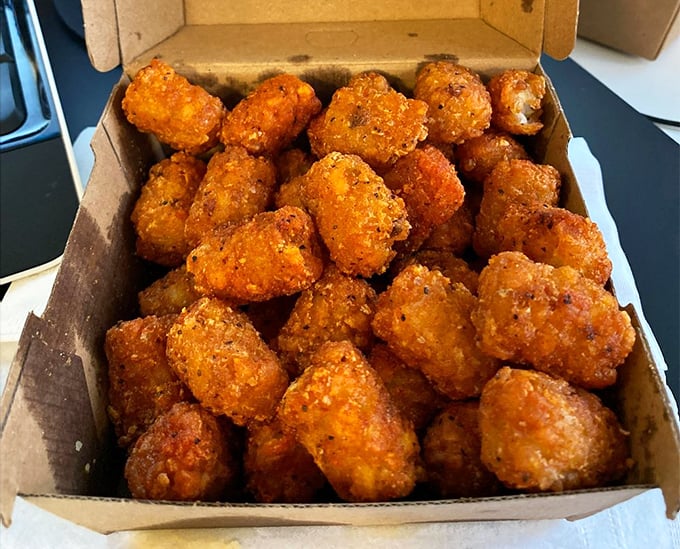 Tater tots transformed into crispy little flavor bombs. These aren't your cafeteria's tots—they're their sophisticated, worldly cousins.