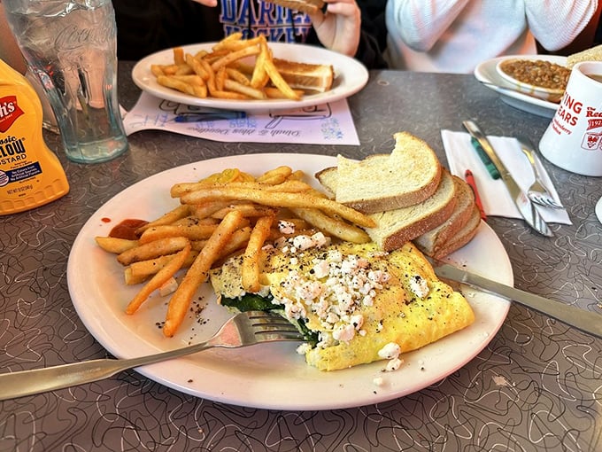 The perfect omelet doesn't exi— Oh wait, here it is, golden and fluffy, keeping company with crispy fries and toast soldiers.