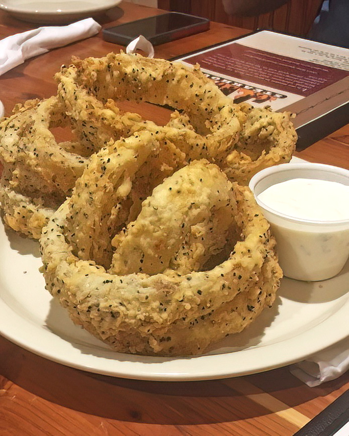 These aren't just onion rings—they're golden halos of crispy perfection that make you wonder why you'd ever waste time on lesser appetizers.