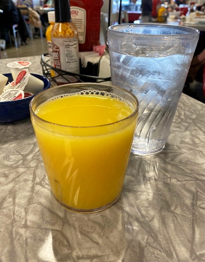 Orange juice so bright it could wake you up before you even take a sip – nature's alarm clock in a water-beaded glass.