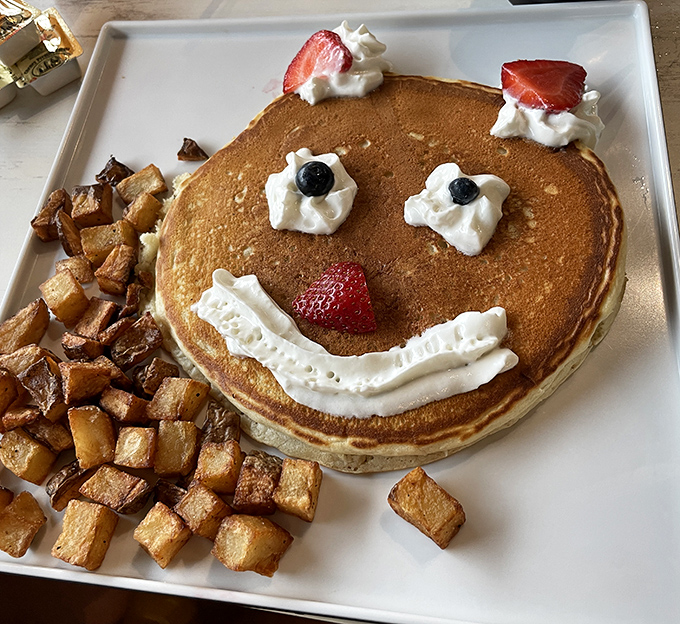 This pancake isn't just smiling at you—it's practically winking, as if to say "I'm worth every delicious calorie."