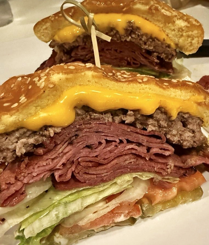 This isn't just a burger with pastrami—it's a diplomatic summit between two iconic sandwiches that decided to join forces for the greater good.