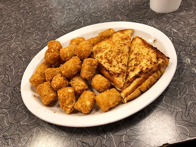 Breakfast perfection that would make Ron Swanson weep with joy. Golden hash browns and perfectly grilled toast—the breakfast of champions.