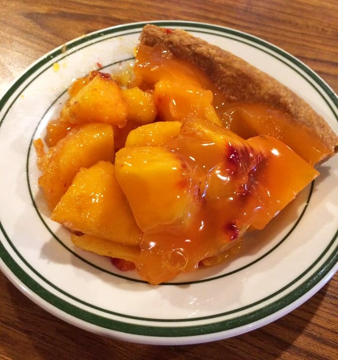 This peach pie doesn't need filters or fancy plating—just juicy fruit chunks swimming in their own sweet nectar, cradled by that perfect crust.