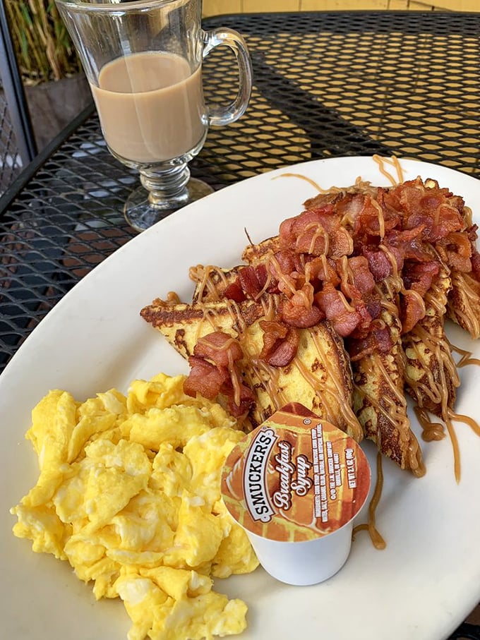 Breakfast decadence: French toast meets scrambled eggs with a side of bacon that appears to have been caramelized to sweet-savory perfection.