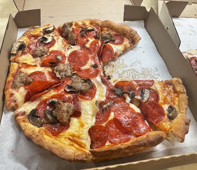 The takeout box can barely contain the glory – pepperoni and mushroom pizza that makes delivery chains weep with inadequacy.