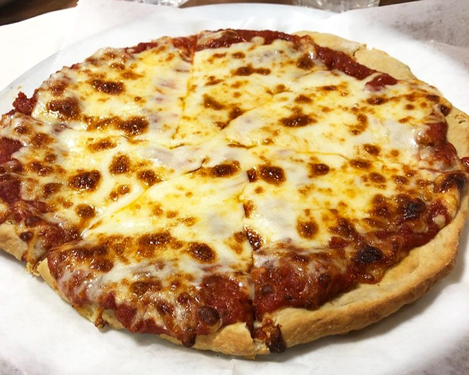 Diner pizza defies expectations with its perfectly melted cheese landscape—proof that sometimes the best Italian food comes from the most American of institutions. 